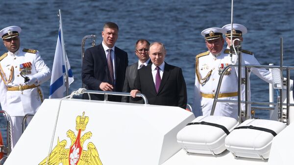 Russian President and Supreme Commander-in-Chief of the Russian Armed Forces Vladimir Putin on the Raptor patrol boat in St. Petersburg on Navy Day. - Sputnik International