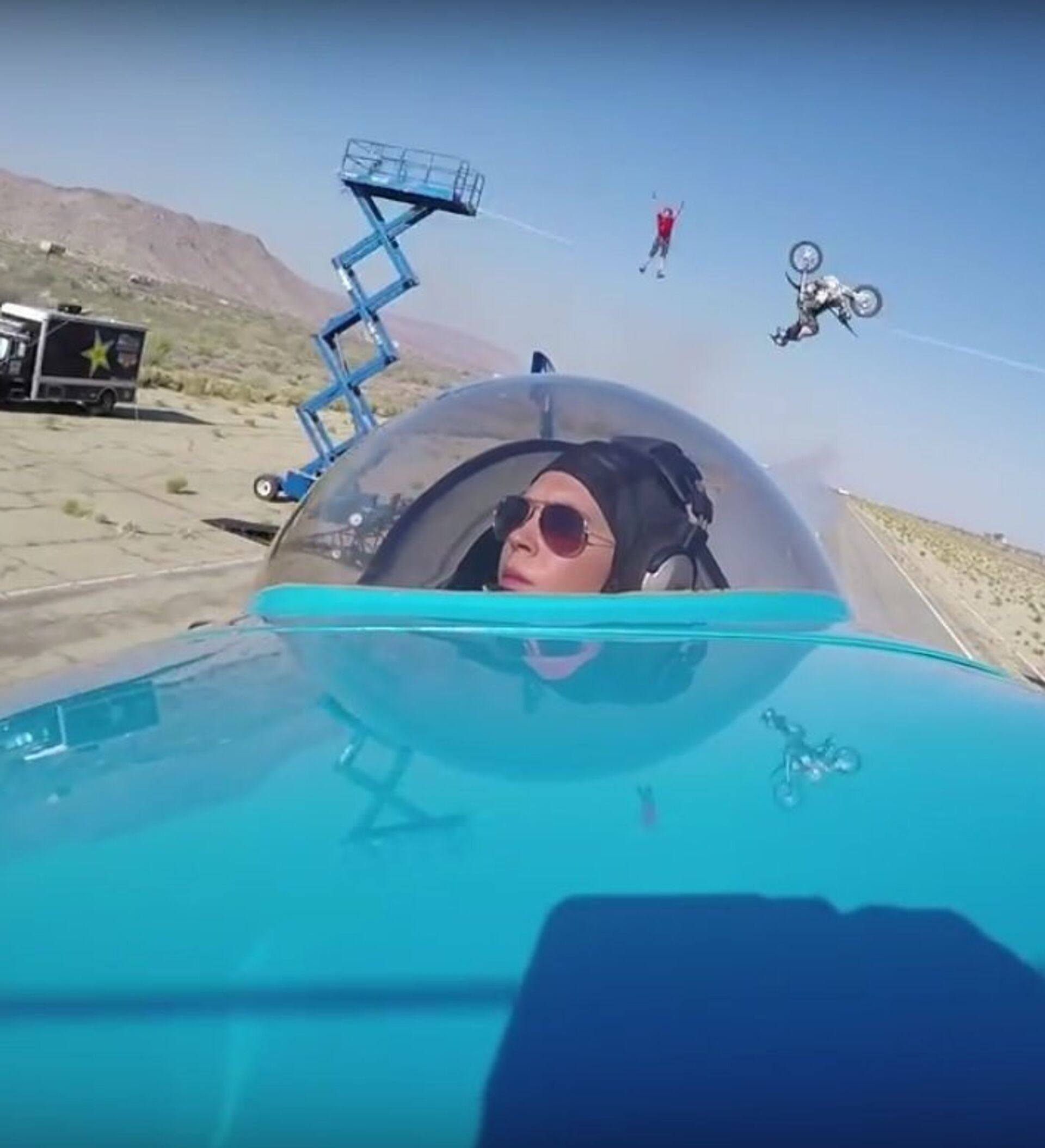Aircraft Flies Under Tightrope Walker, Motorcycle Rider Doing Backflip ...